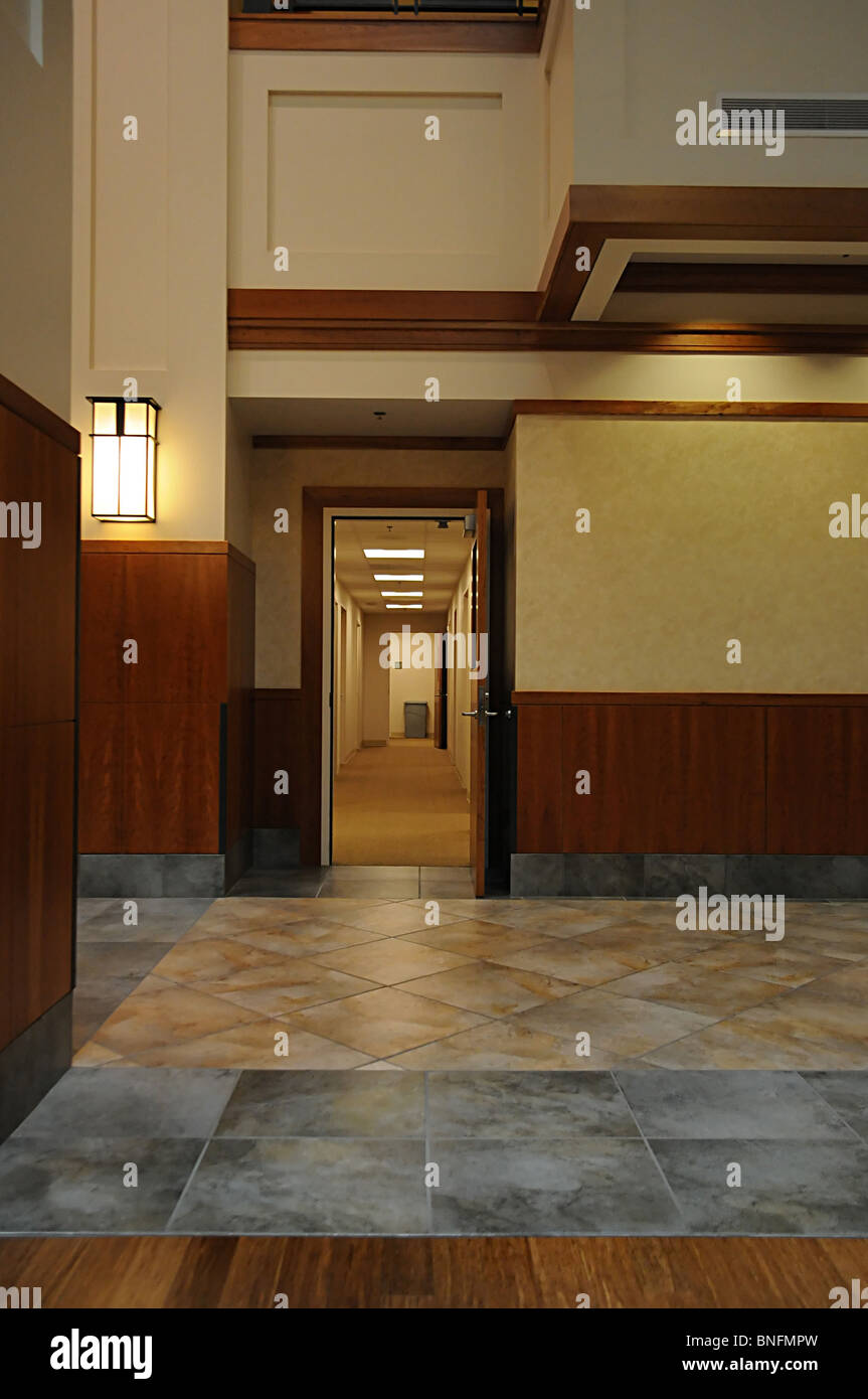 Open door in modern building leading down a hallway Stock Photo - Alamy