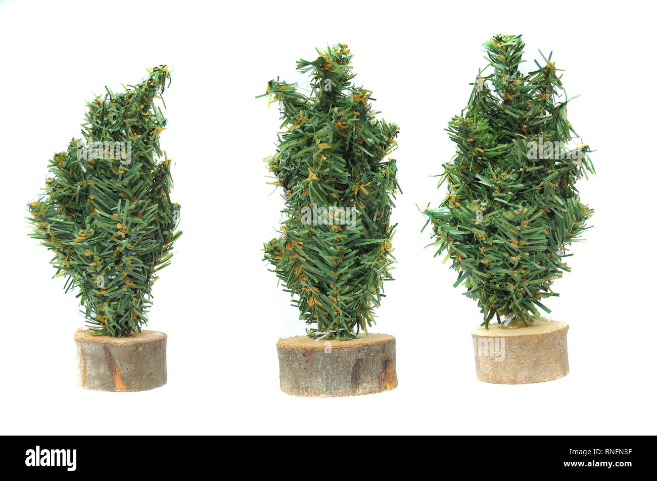 Miniature plastic christmas tree figures isolated on white background ...