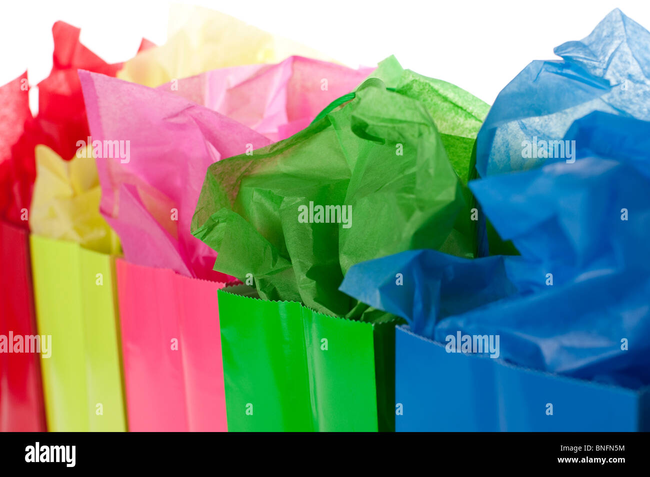 MultiColored Gift Bags with colorful tissue studio image Stock Photo ...