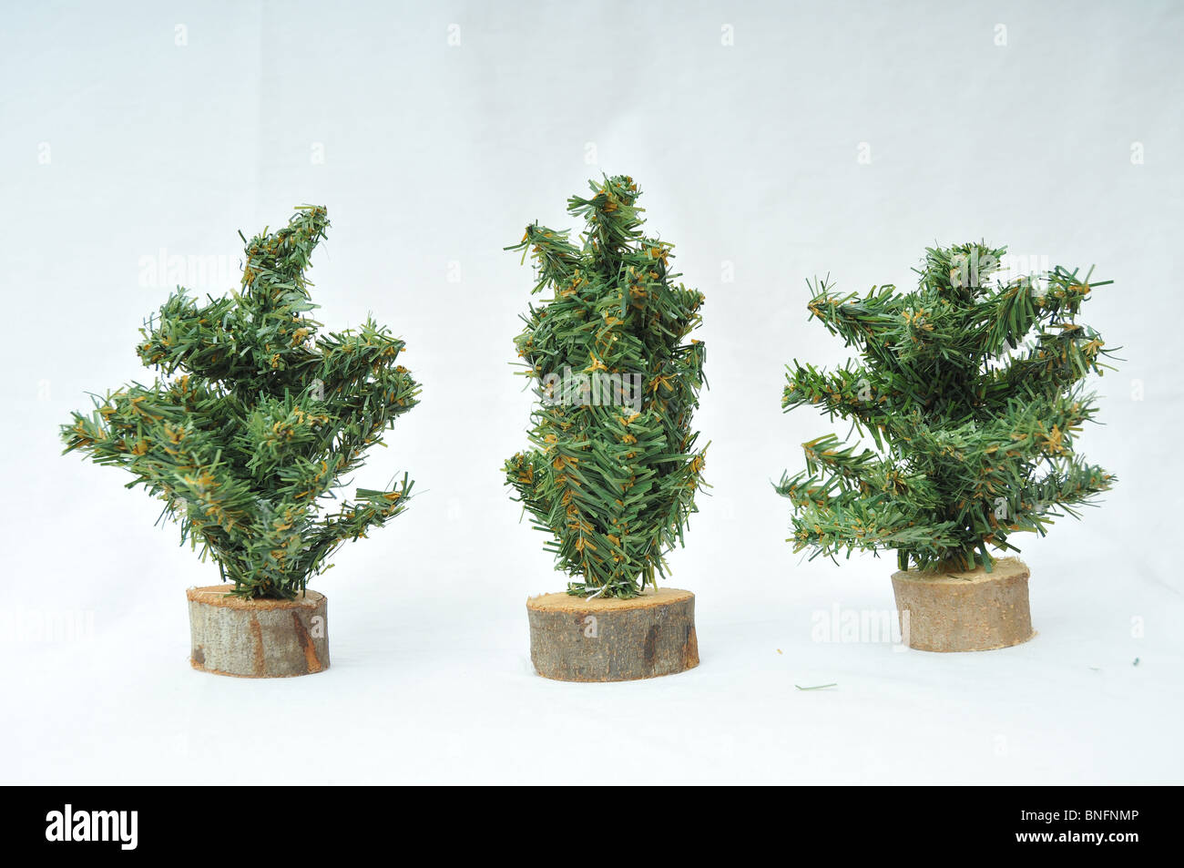 Miniature plastic christmas tree figures isolated on white background ...