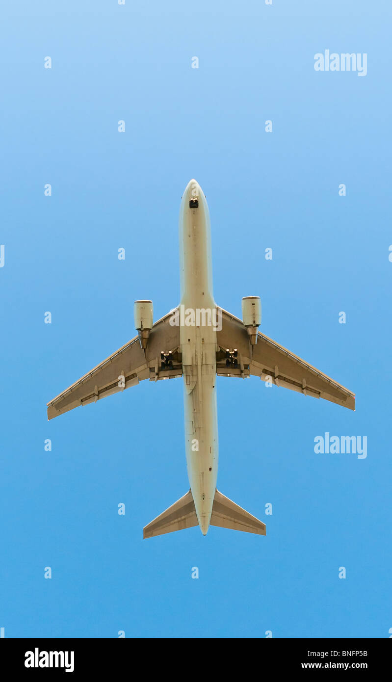 Looking straight up at a commercial jet airliner on final approach for ...