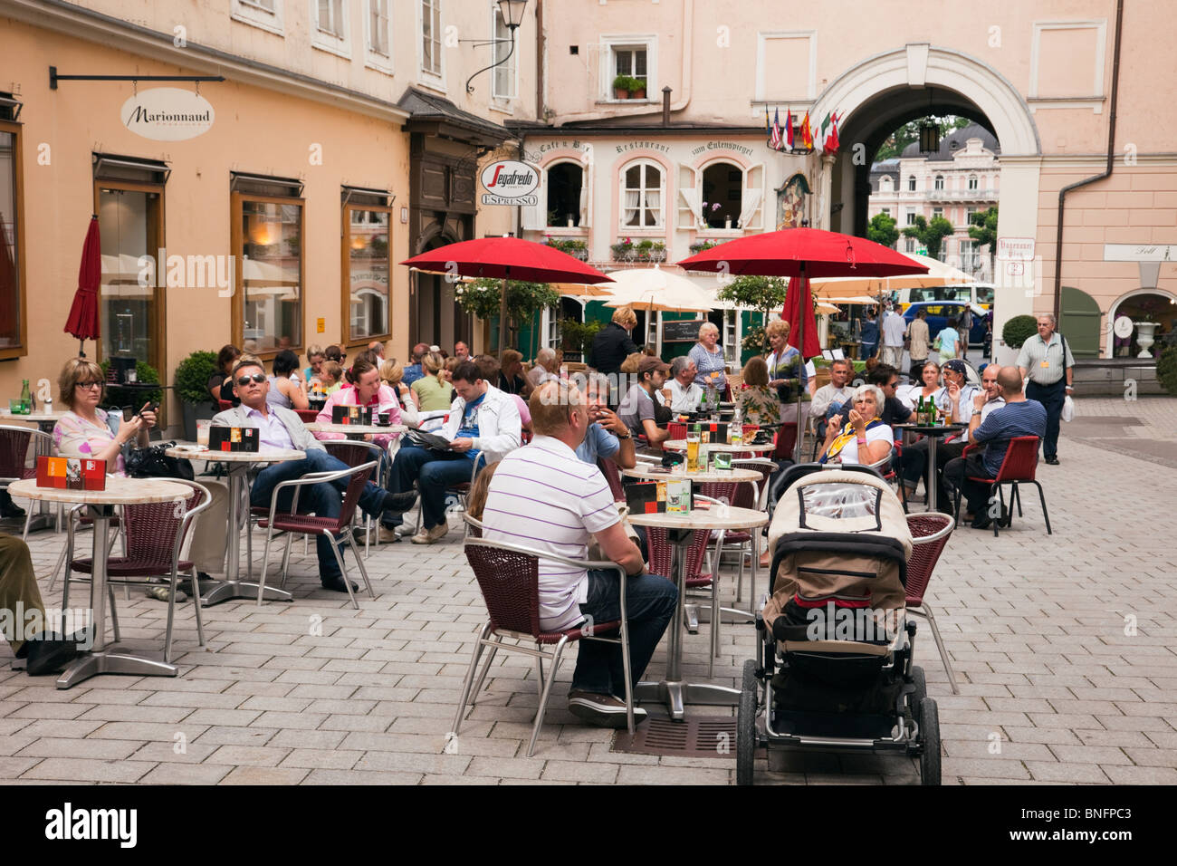People sitting outside in a pavement cafe in the historic city ...