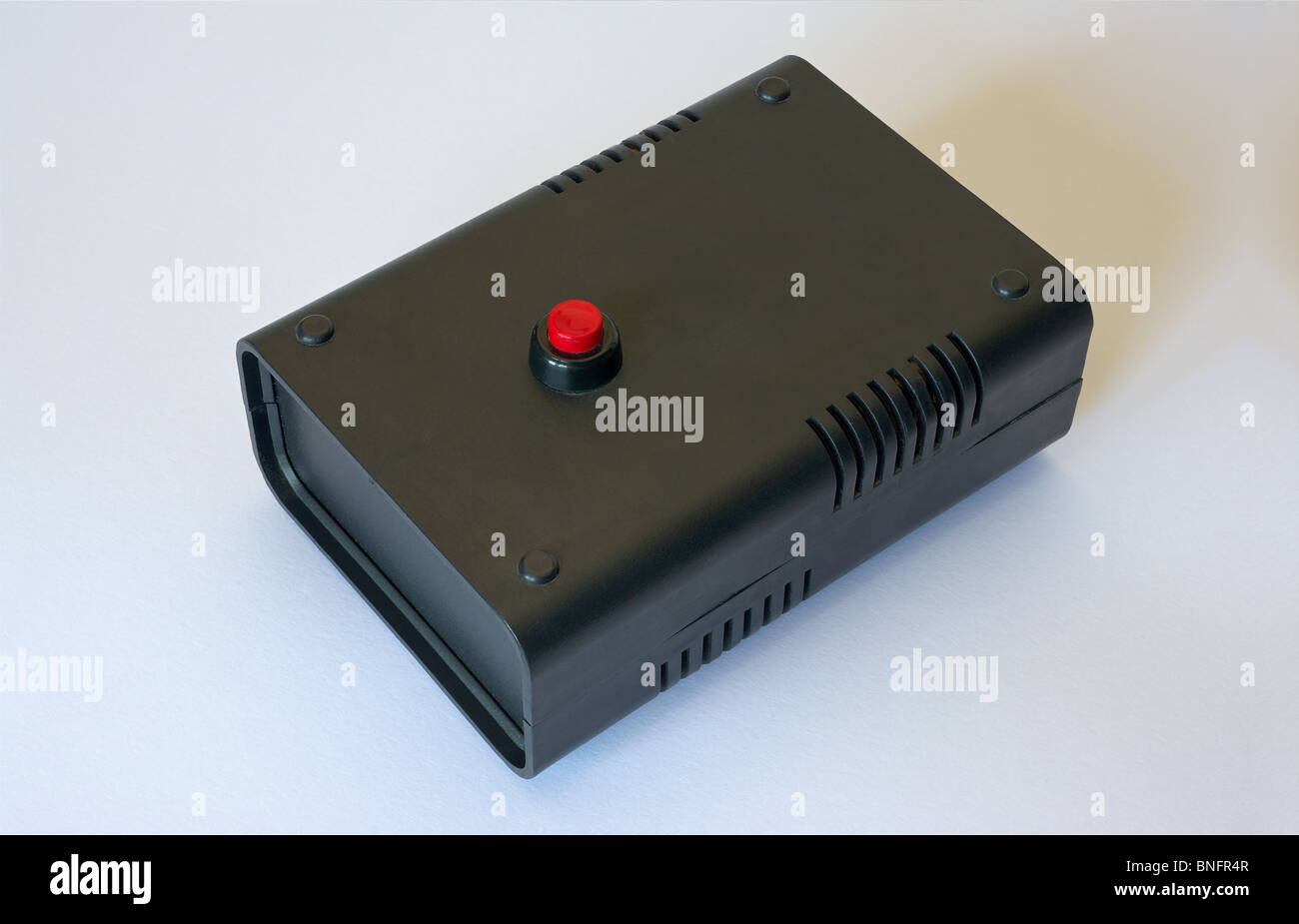 Black electrical box with red button Stock Photo - Alamy