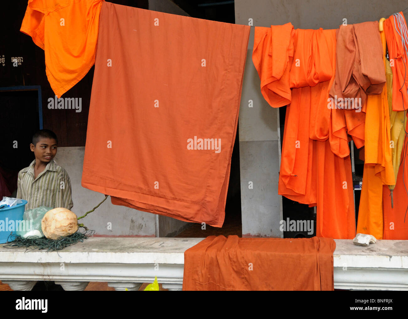 Orange monk robes hanging in Buddhist monastery, Cambodia Stock Photo ...