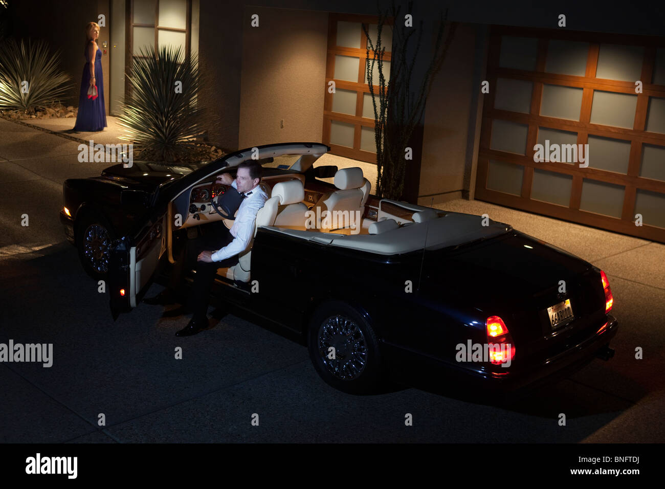 Man leaving building in convertible car Stock Photo - Alamy