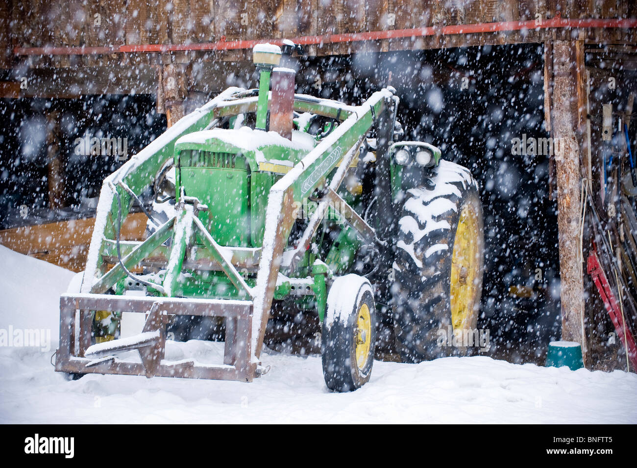 Tractor near a barn during heavy snow, Bozeman, Montana, USA Stock ...