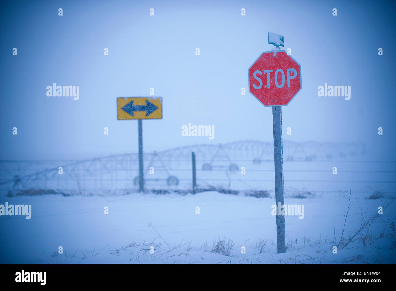 Road signs in a snow covered field, Bozeman, Montana, USA Stock Photo ...