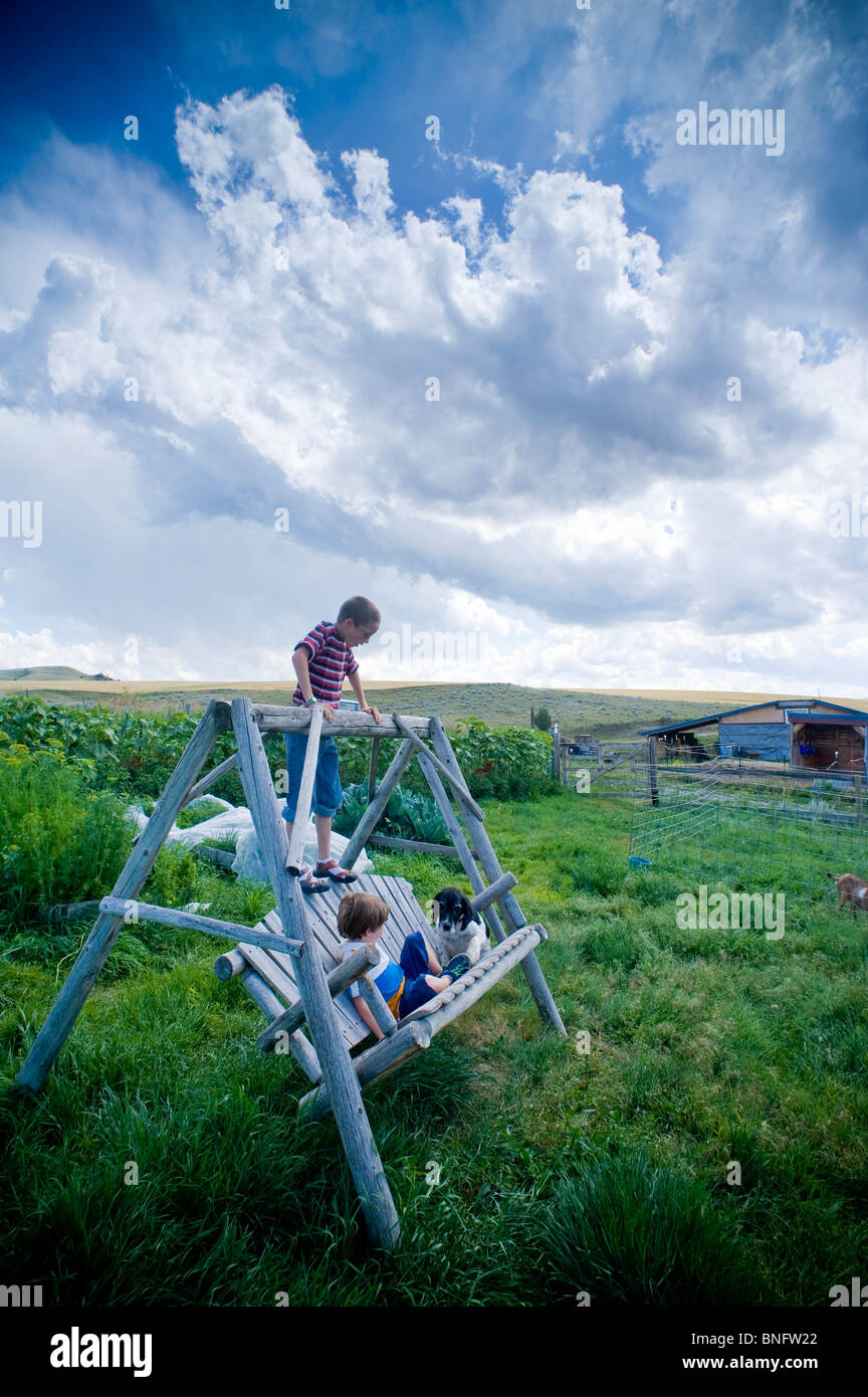 Two boys playing on swing hi-res stock photography and images - Alamy