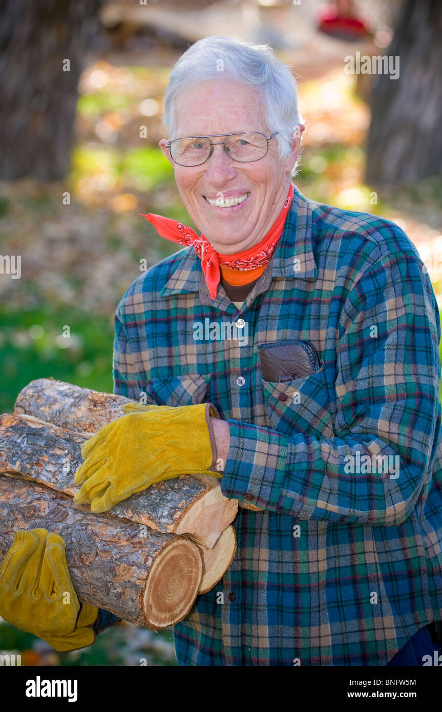 Senior man carrying firewood, Bozeman, Montana, USA Stock Photo - Alamy