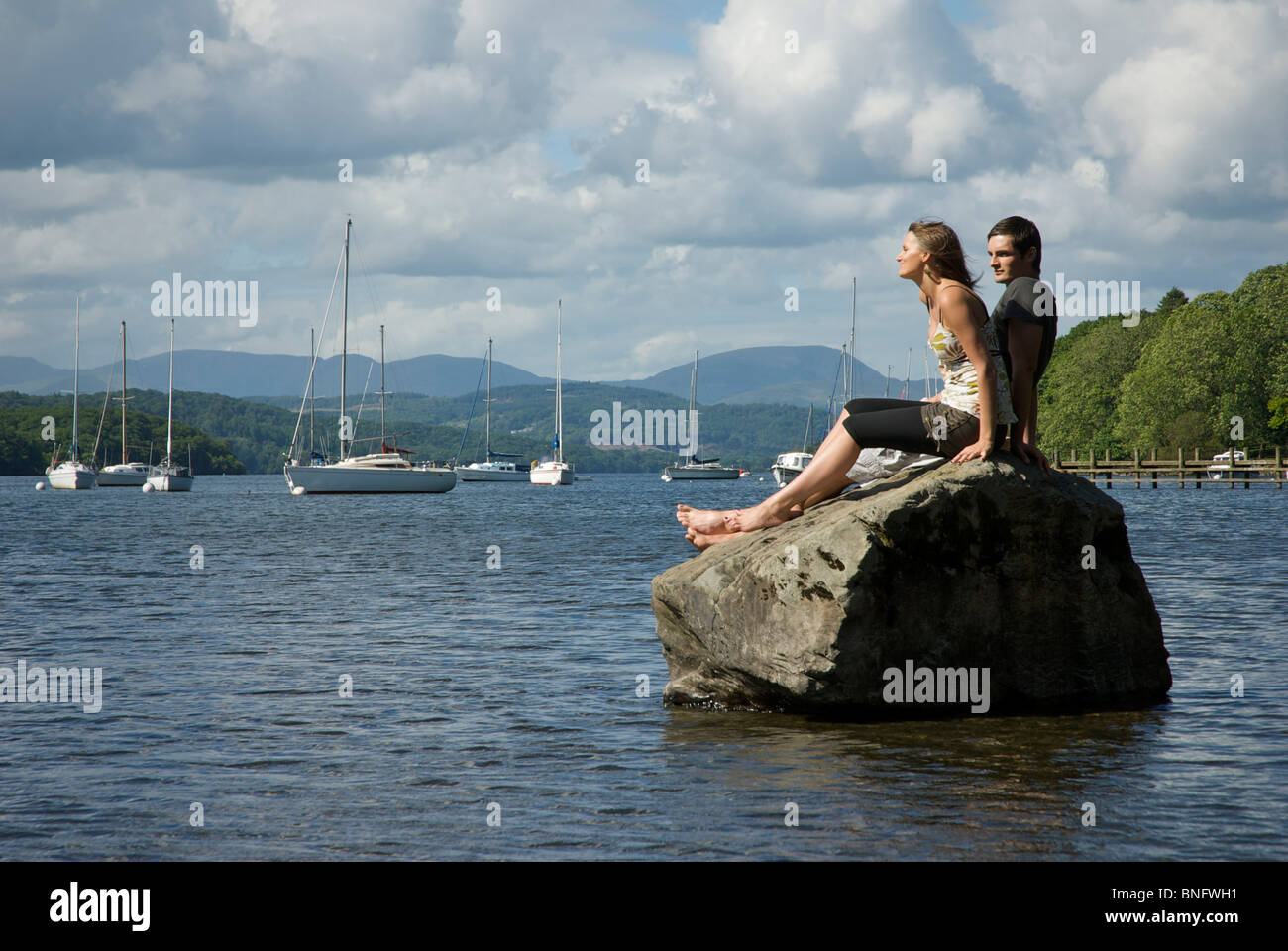 Young couple relaxing at Fell Foot Park, Lake Windermere, Lake District ...