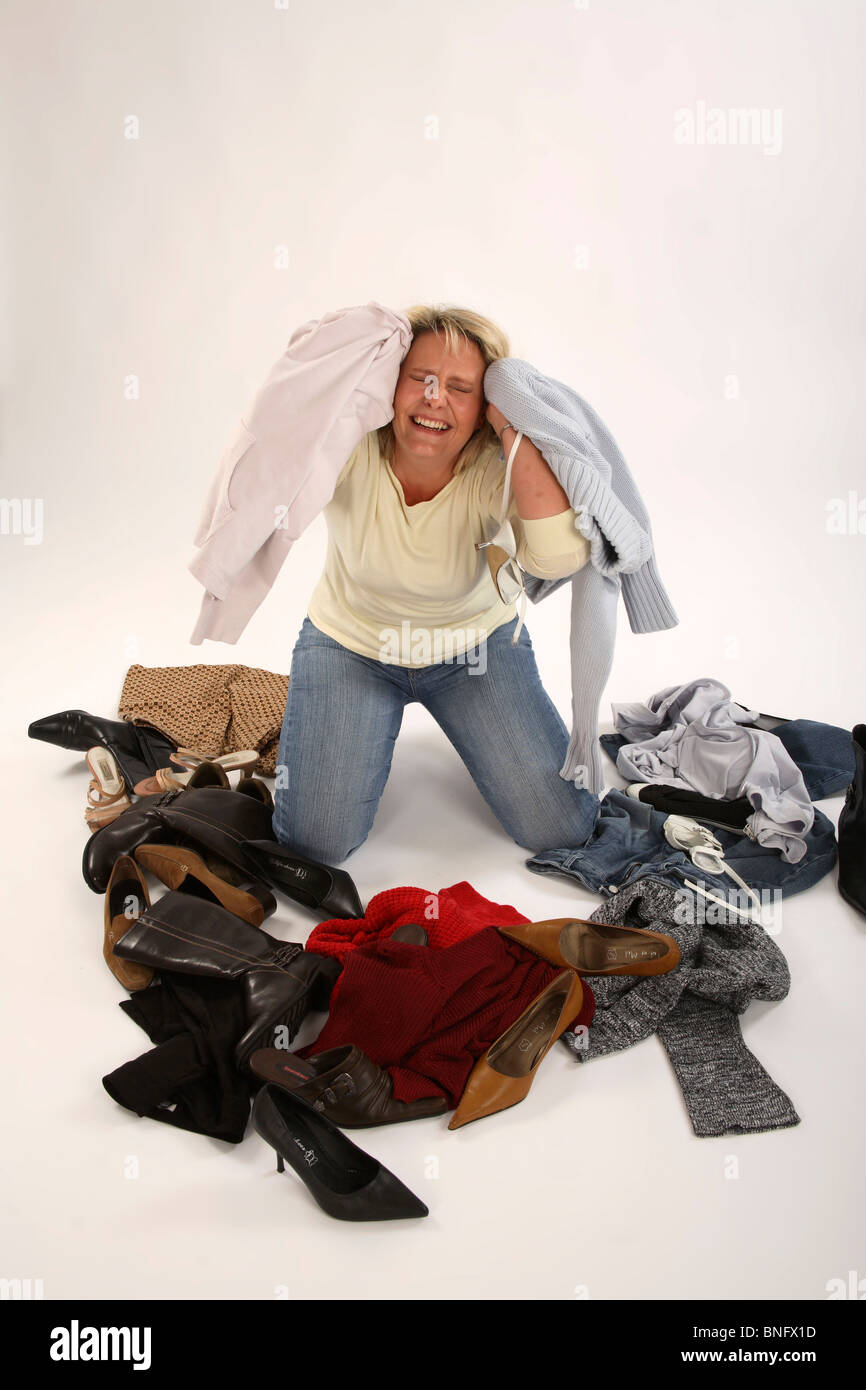 Woman between clothes Stock Photo - Alamy
