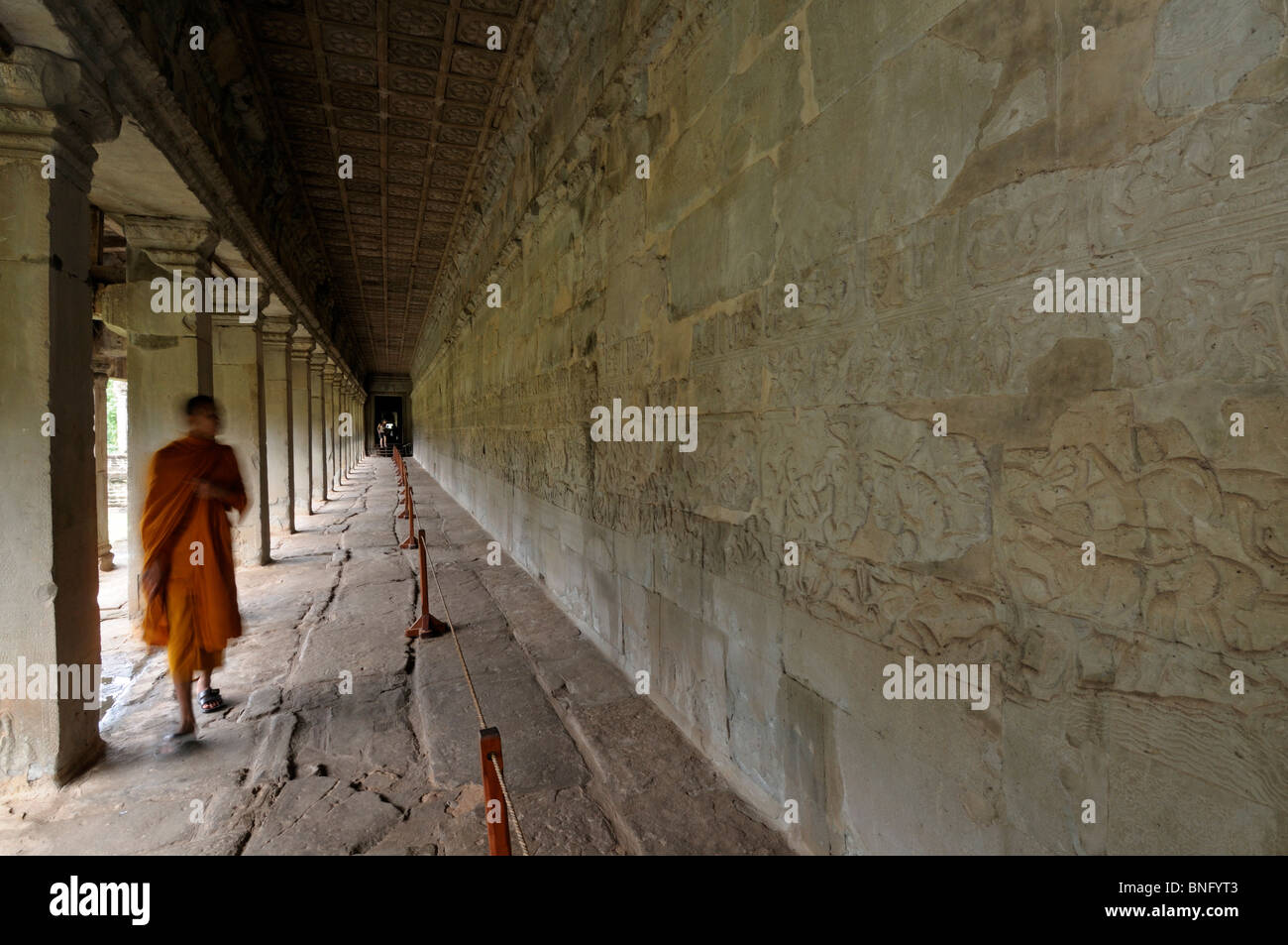 Buddhist monk inspects the bas reliefs of Angkor Wat, Cambodia Stock ...