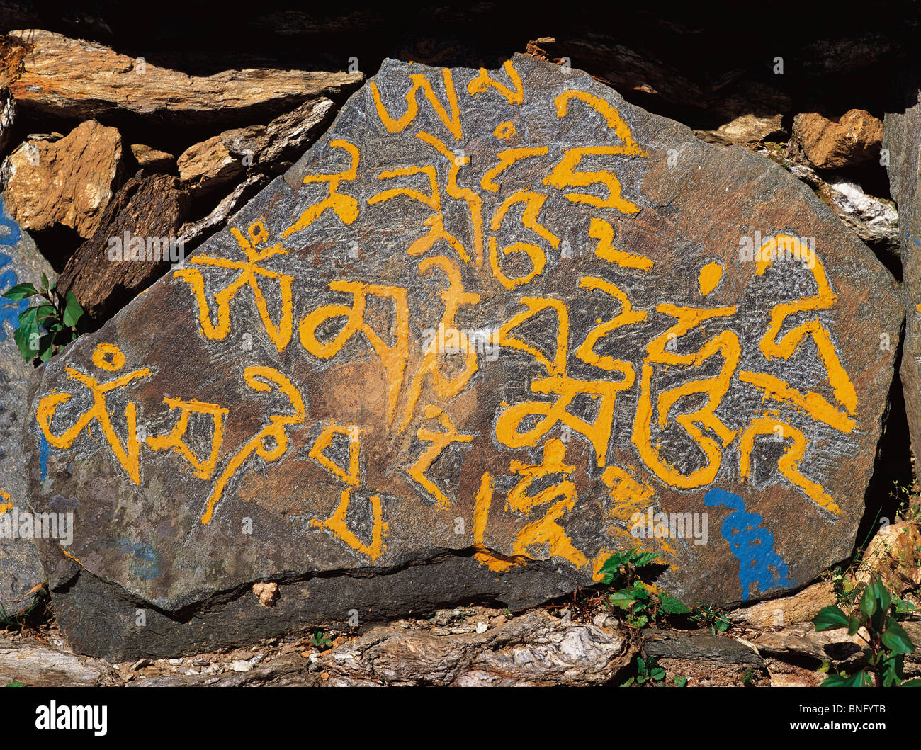 Carved mane-stone carrying the Buddhist message "Om mane Padme hom" by ...