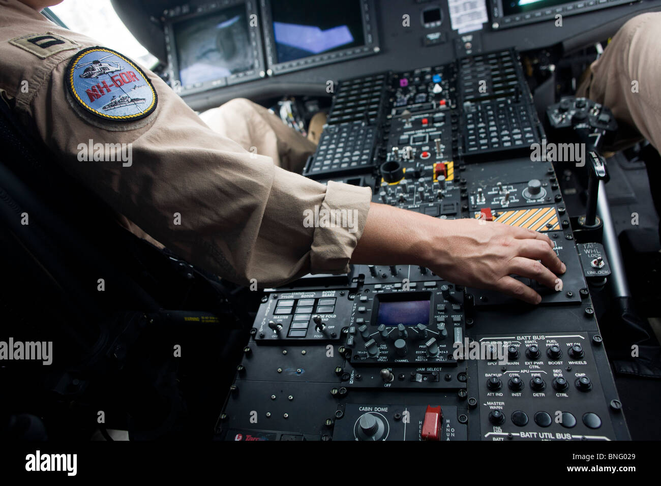 US Navy pilots sit in the cockpit of a Sikorsky MH-60R helicopter at ...