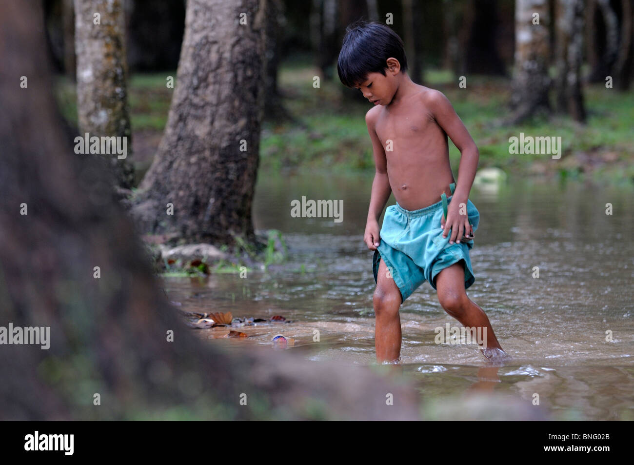 Little boy knee-deep in water, Cambodia Stock Photo - Alamy