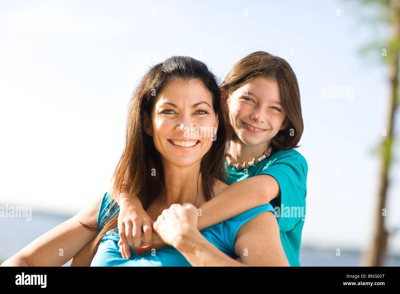Girl smiling with her mother Stock Photo - Alamy