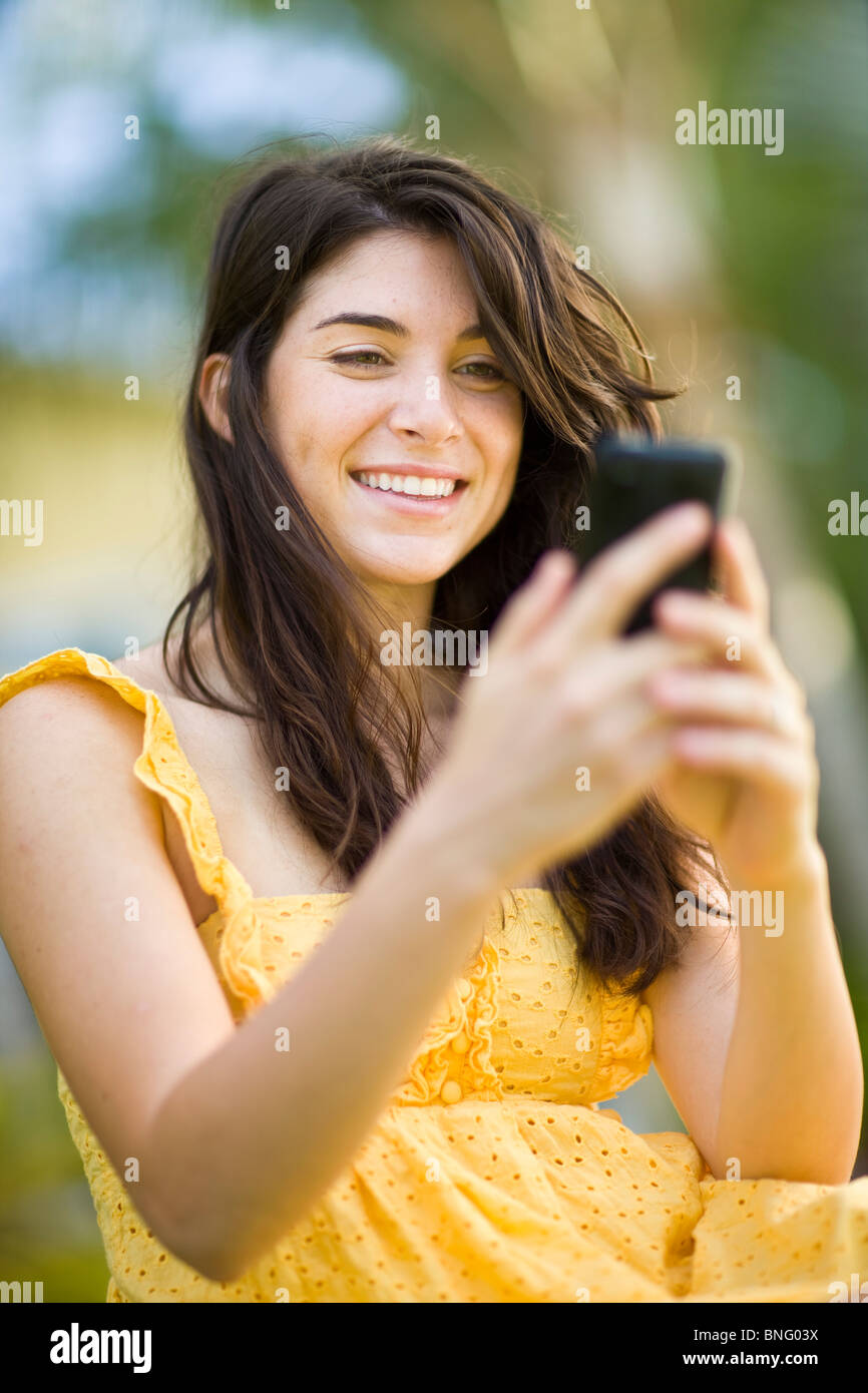 Young woman text messaging on a mobile phone Stock Photo - Alamy