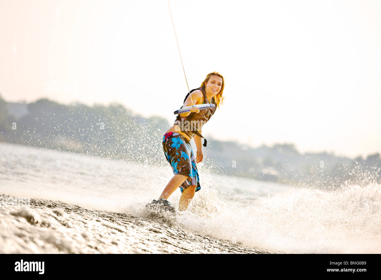 Young woman wakeboarding in the sea Stock Photo - Alamy