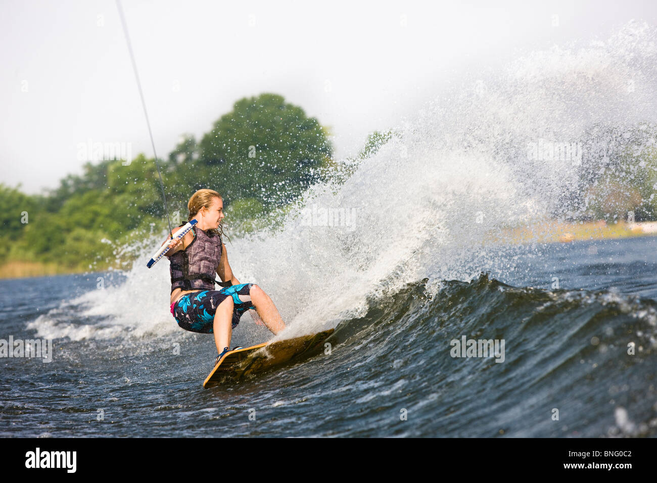 Young woman wakeboarding in the sea Stock Photo - Alamy