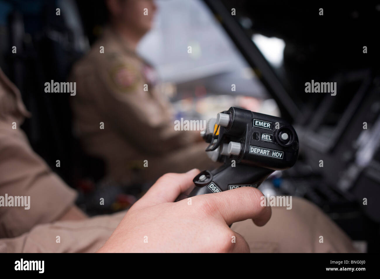 US Navy pilot grasps cyclic stick in the cockpit of a Sikorsky MH-60R ...