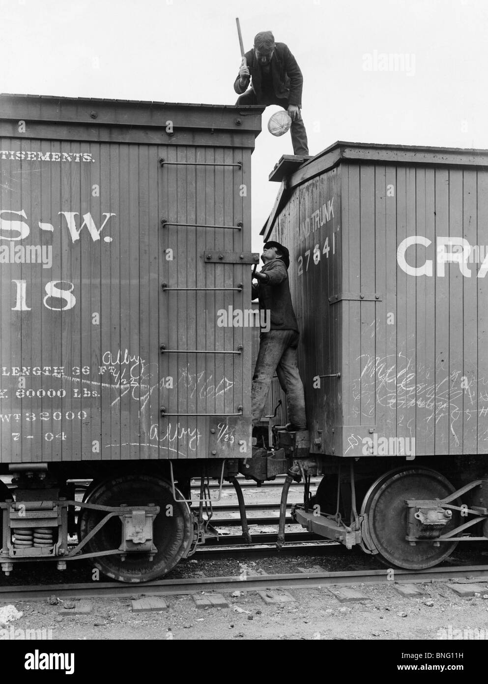 USA, two men standing between train carriages Stock Photo - Alamy