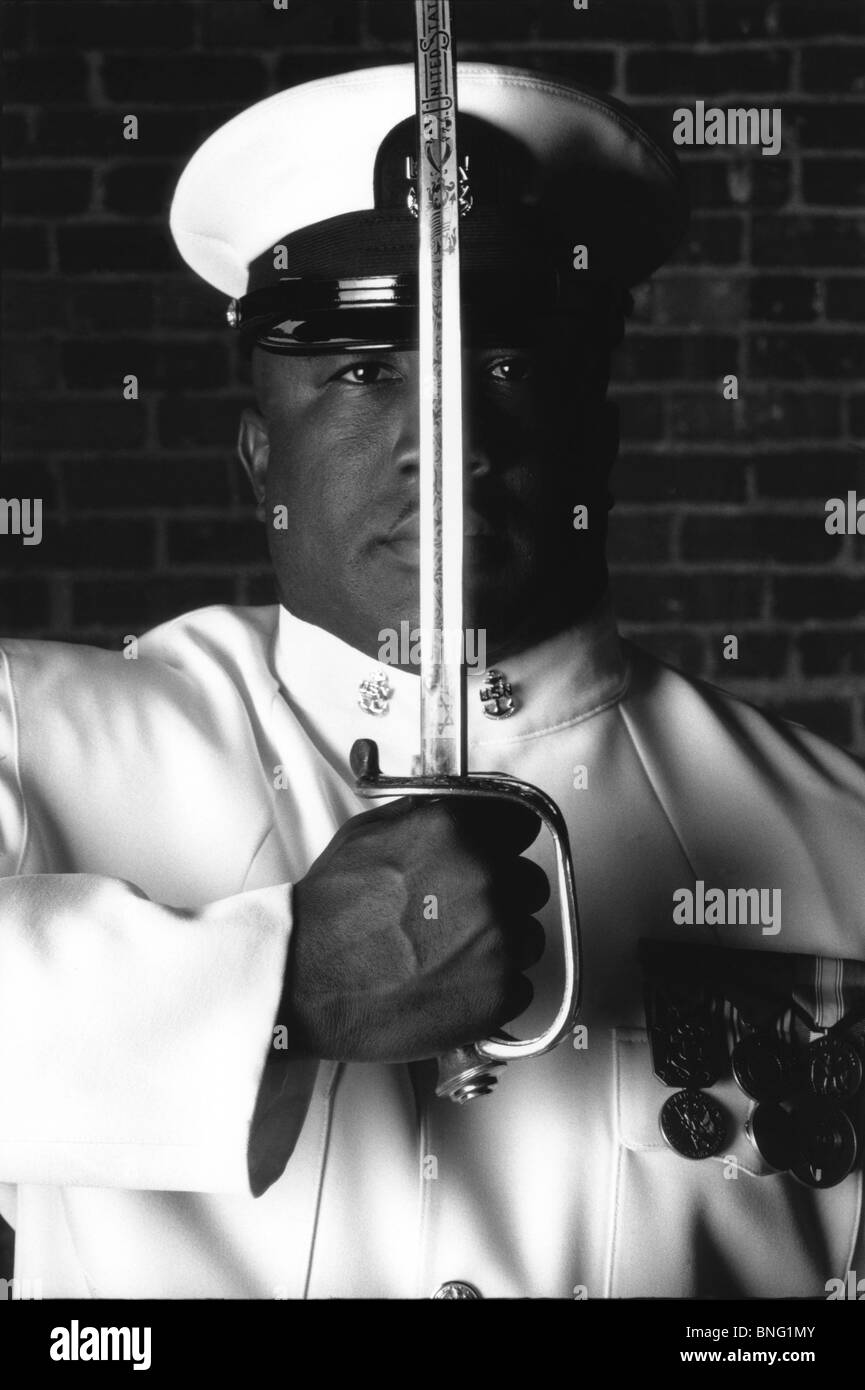 Navy officer holding a sword in front of his face Stock Photo - Alamy
