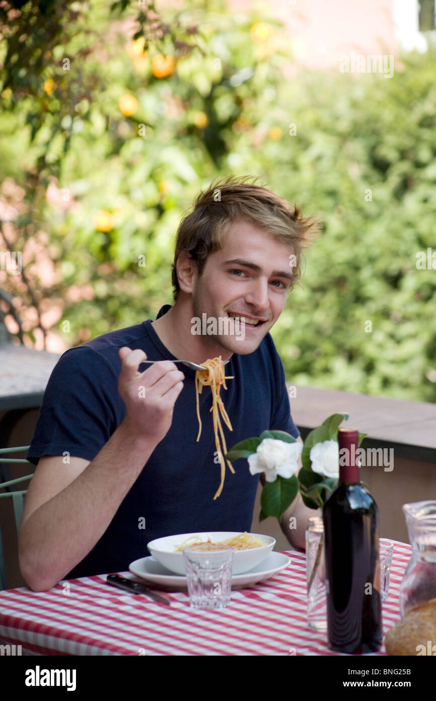 young caucasian man eating spaghetti Stock Photo - Alamy