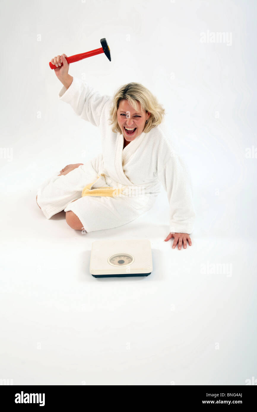 Woman destroying scales Stock Photo - Alamy