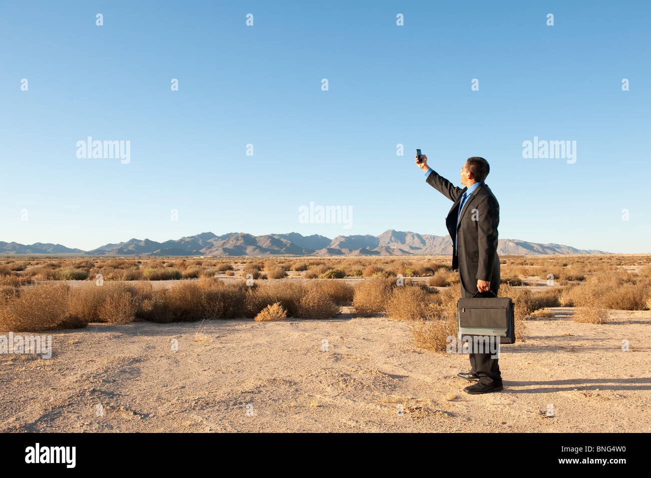 Businessman taking picture with a camera phone, Phoenix, Arizona, USA ...