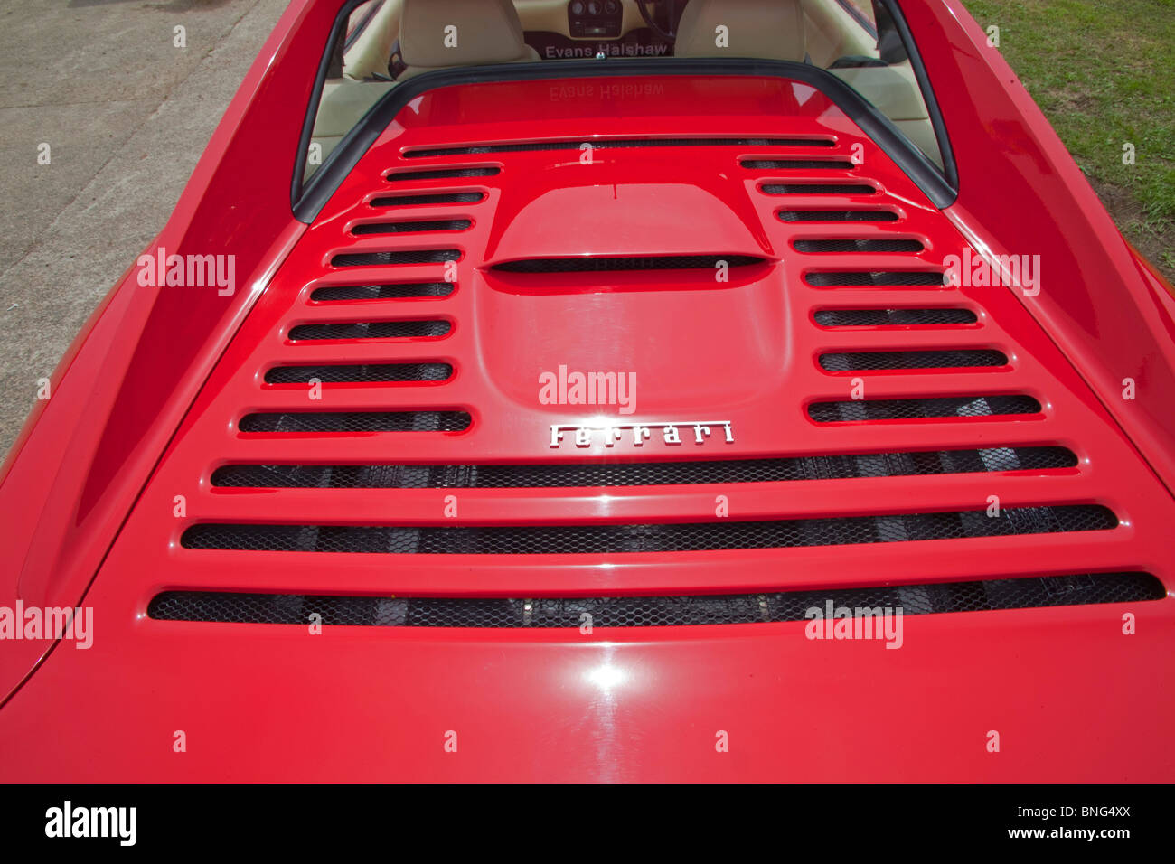 Red Ferrari vintage car engine grille and badge, at car show. View ...