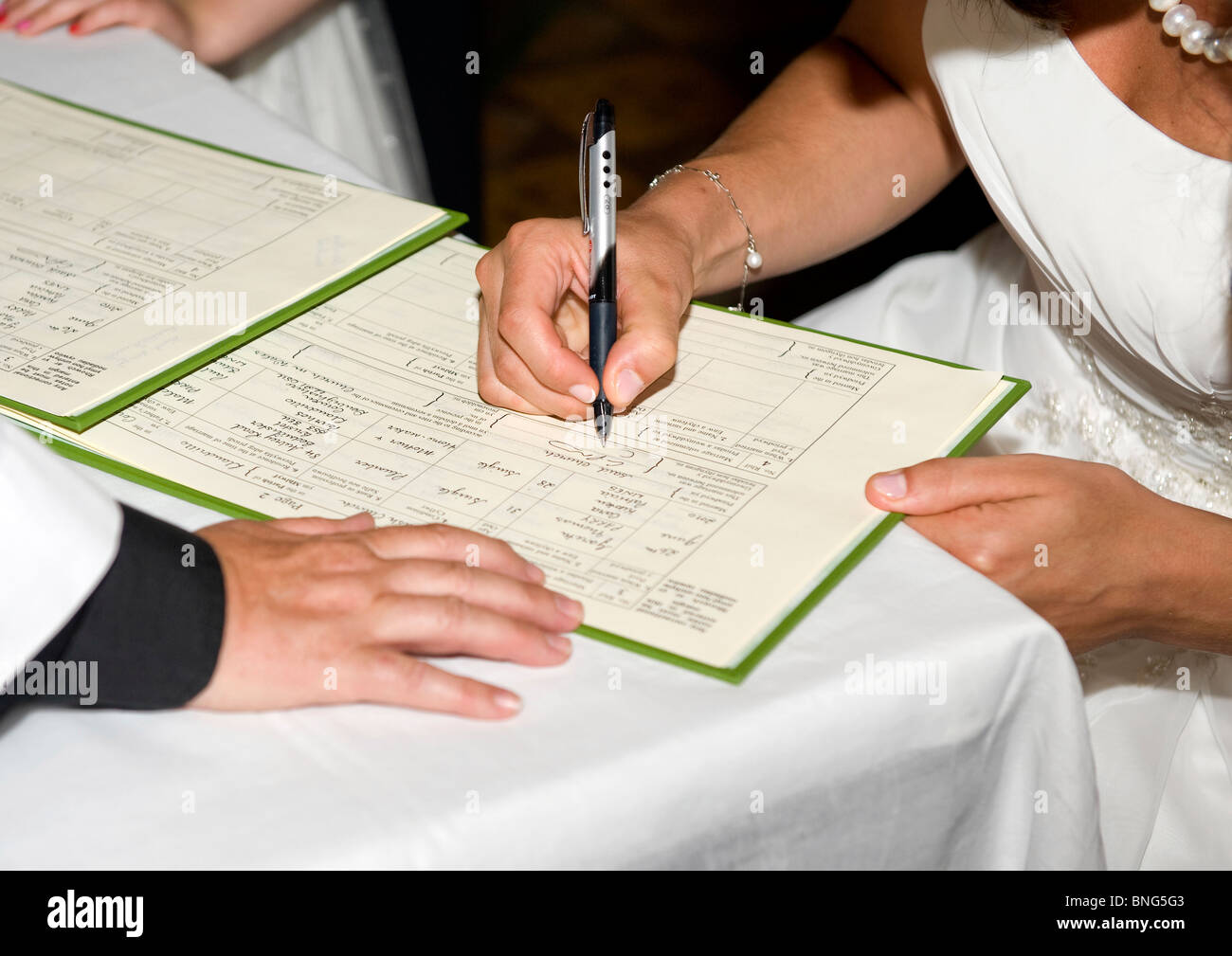 Bride signing the register inside the church Stock Photo - Alamy