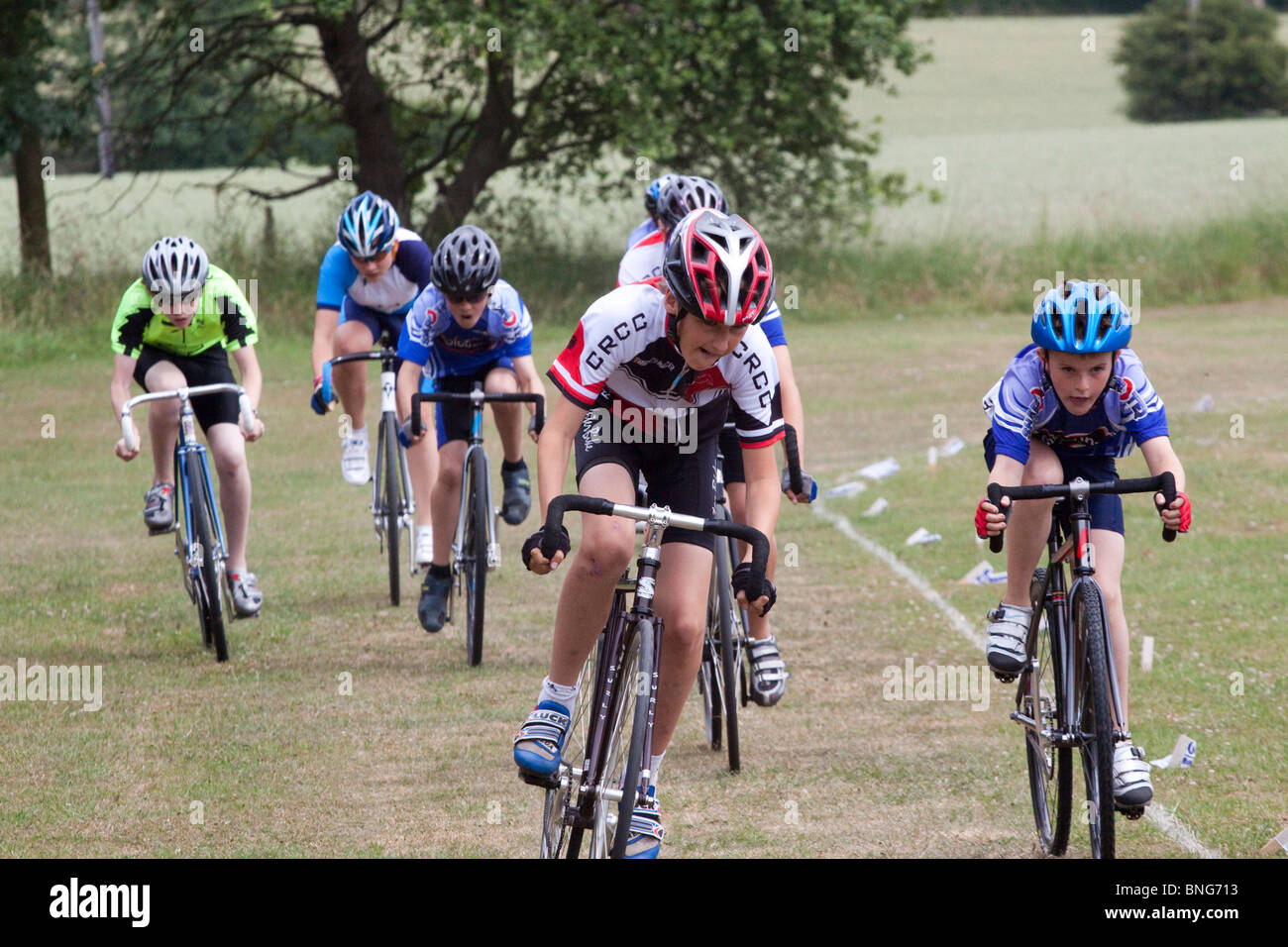Young boys grass track racing on bicycles Stock Photo - Alamy