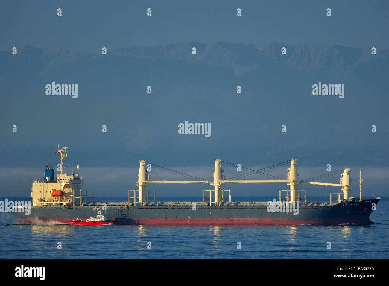 Pilot boat and a container ship in the sea, Victoria, Vancouver Island ...