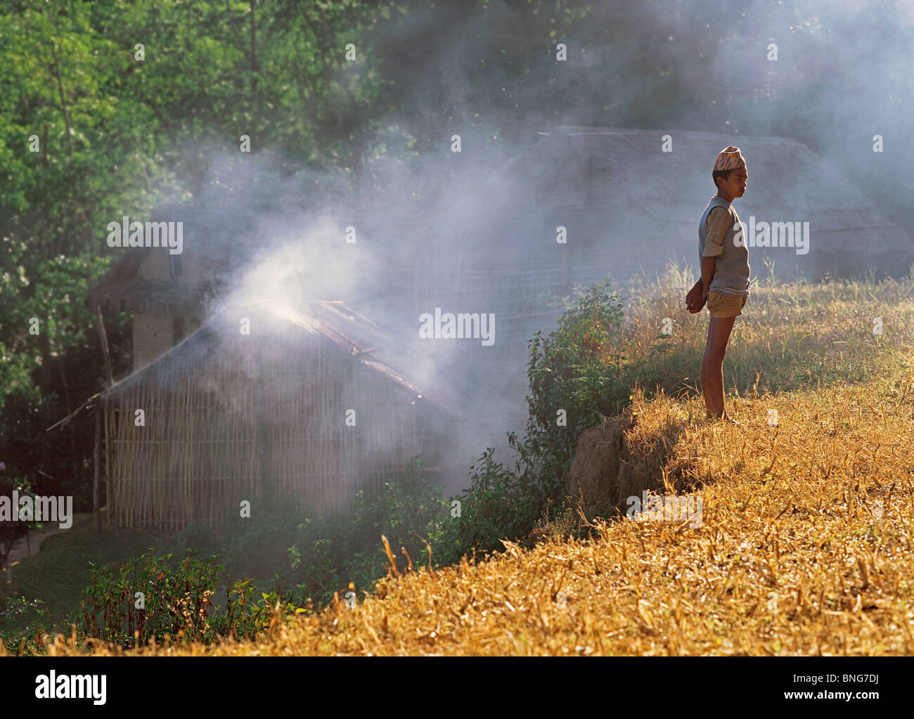 Early morning smoke from cooking fires in the village of Dingla in east ...