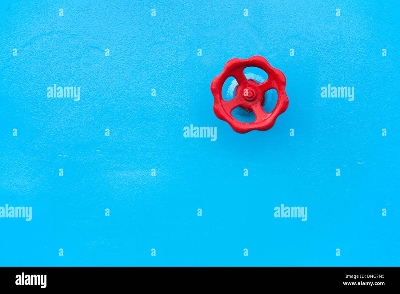 The red valve on a blue background Stock Photo - Alamy
