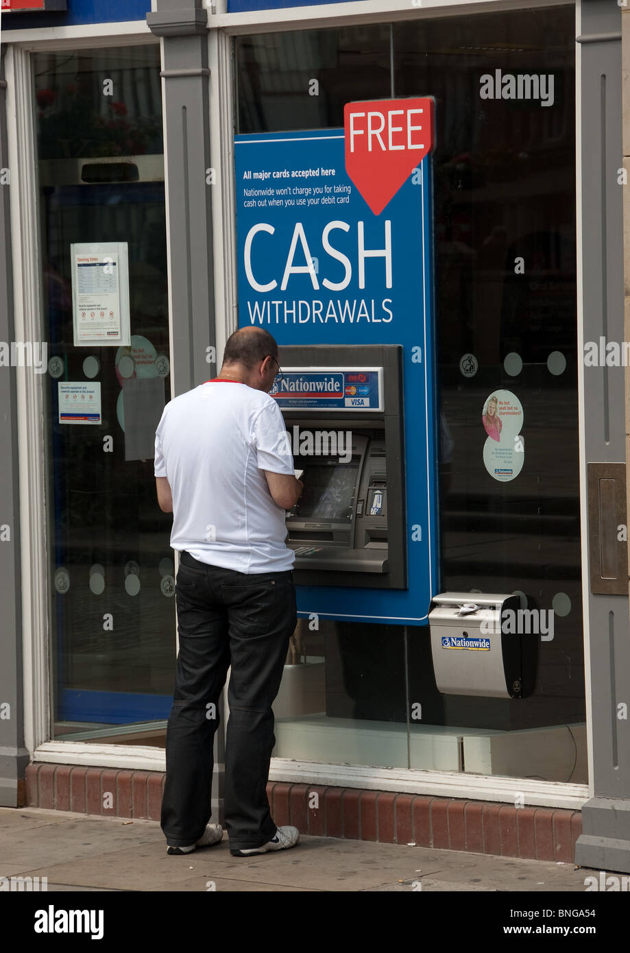 Man drawing cash from automatic telling machine Stock Photo - Alamy