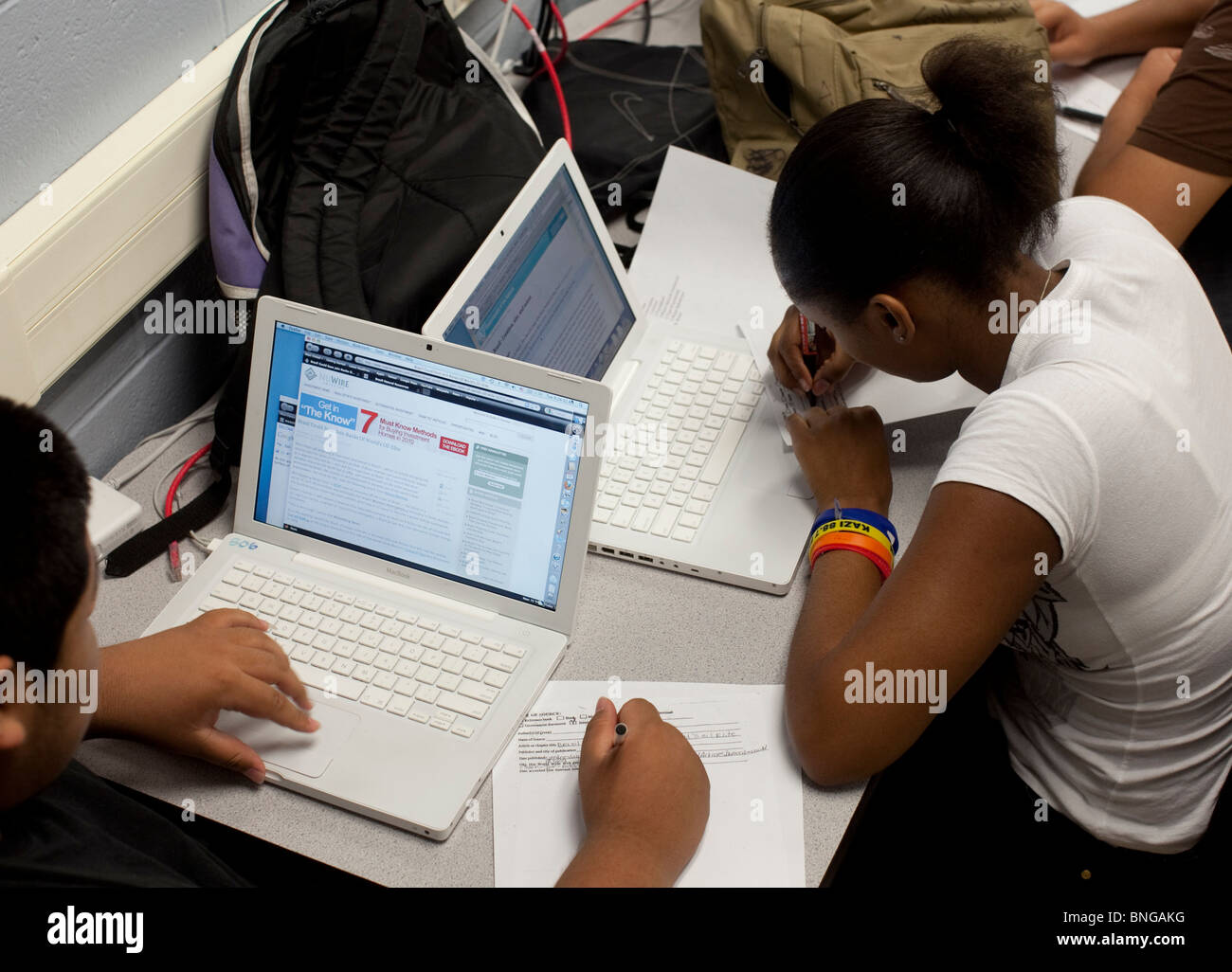 Students use laptop computers to do research on the internet in class ...