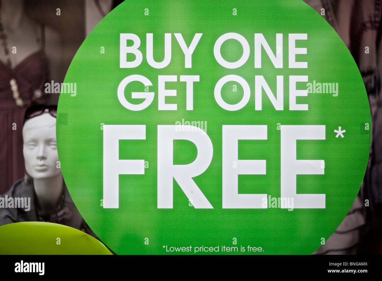 Buy one get one free poster in department store window on High Street ...