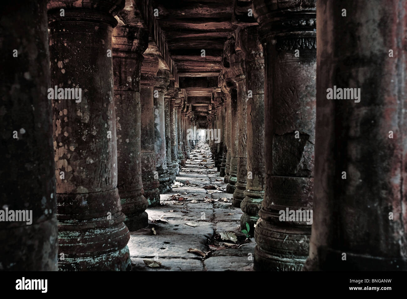 Long stone corridor in Cambodian temple ruins Stock Photo - Alamy