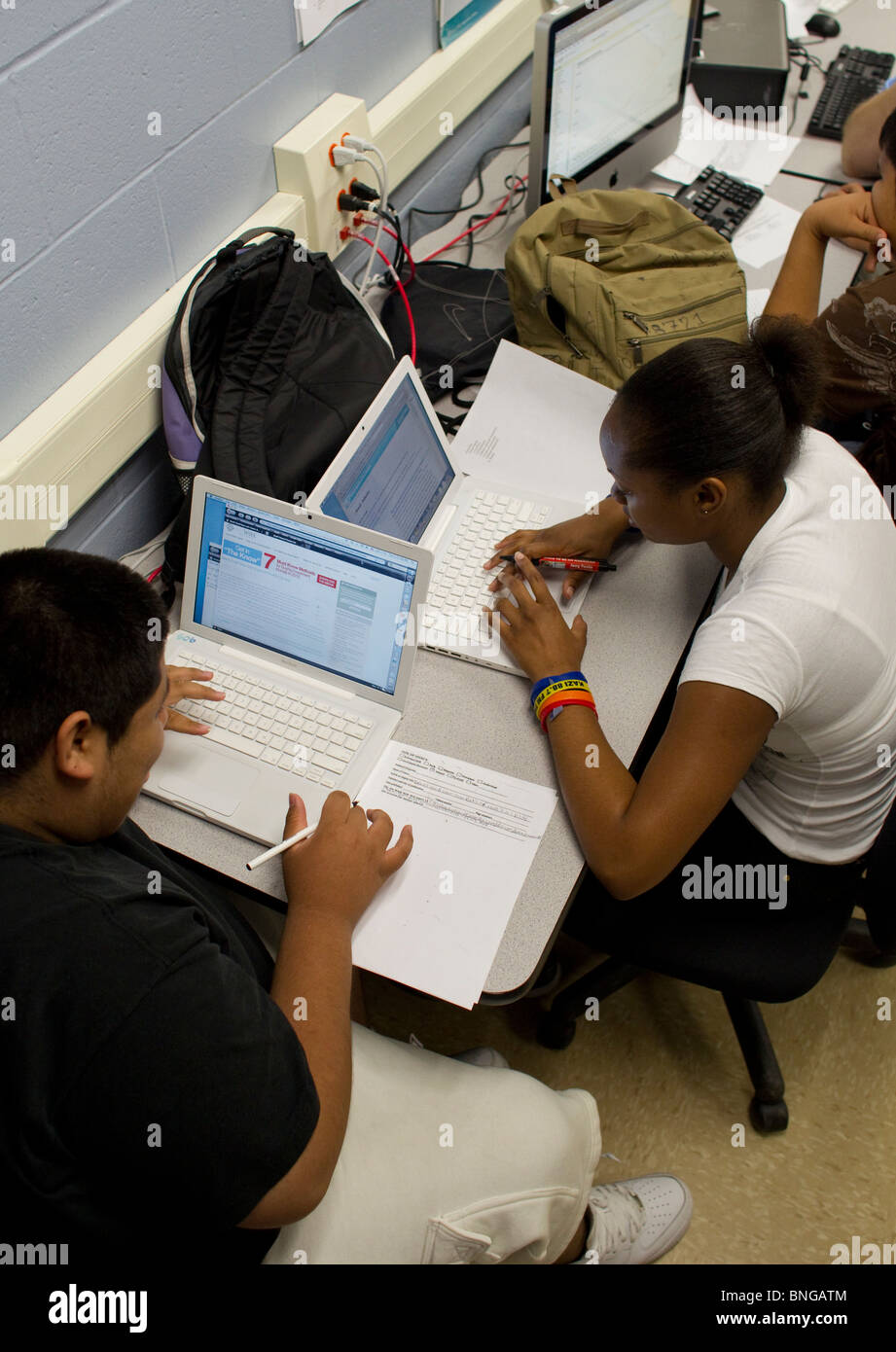 High school students do research online with laptop computers in world ...