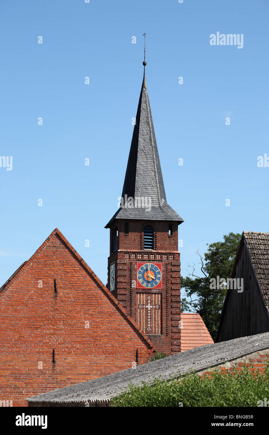 The decorated church tower and farm buildings within the small village ...