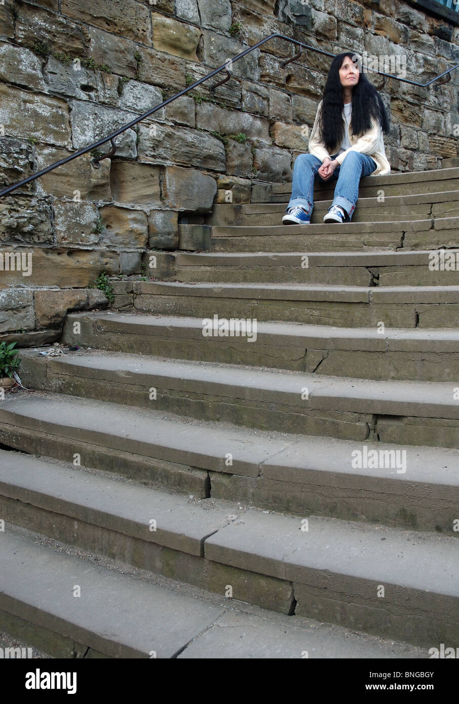 Young woman sitting stone steps outdoors hi-res stock photography and ...