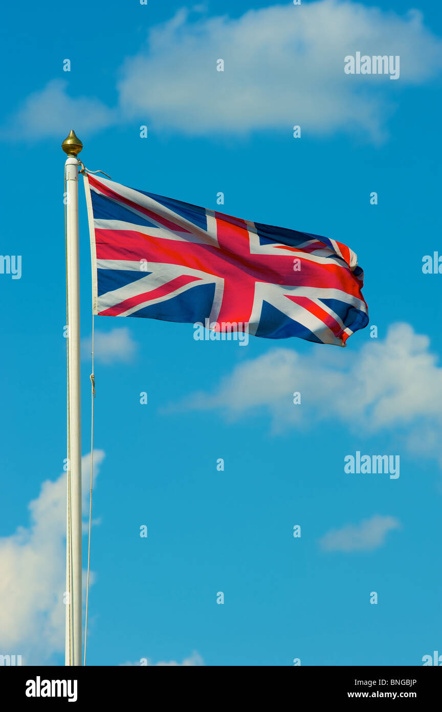 Union jack flag against blue sky Stock Photo - Alamy