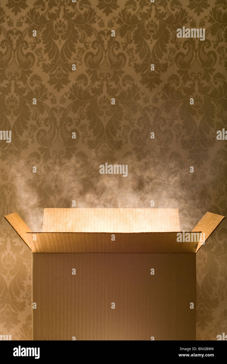 Empty cardboard box with magic dust coming out of it Stock Photo - Alamy
