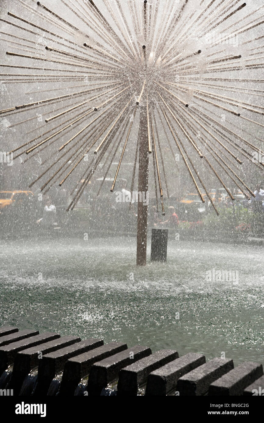 close up view sparkling refreshing falling water of dandelion fountain ...