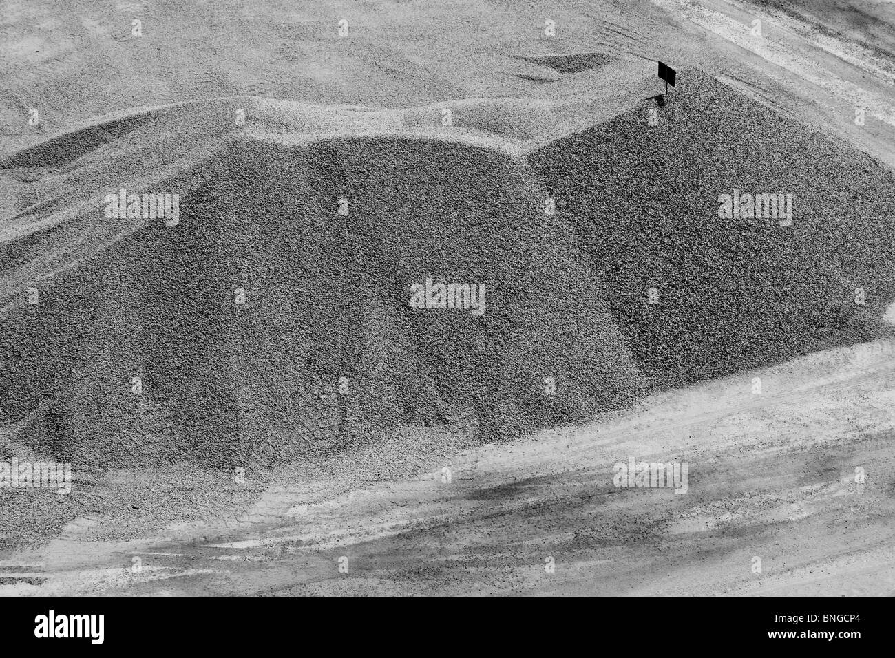 gravel pile with sign on top at sand and gravel plant Stock Photo - Alamy