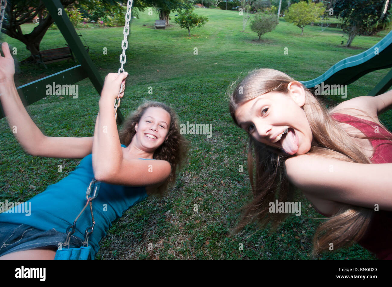 Teenage girls on swing set, Kauai, Hawaii Stock Photo - Alamy
