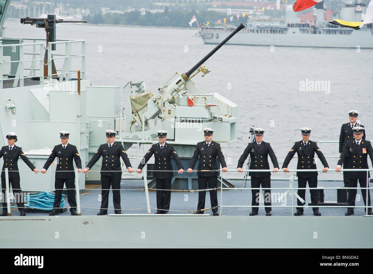 Crew man the rails of the Canadian Navy minesweeper HMCS SHAWINIGAN ...