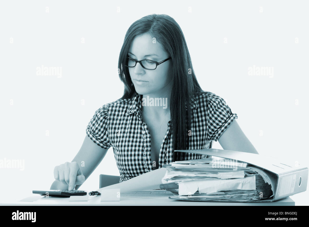 Female executive filling out tax forms while sitting at her desk Stock ...