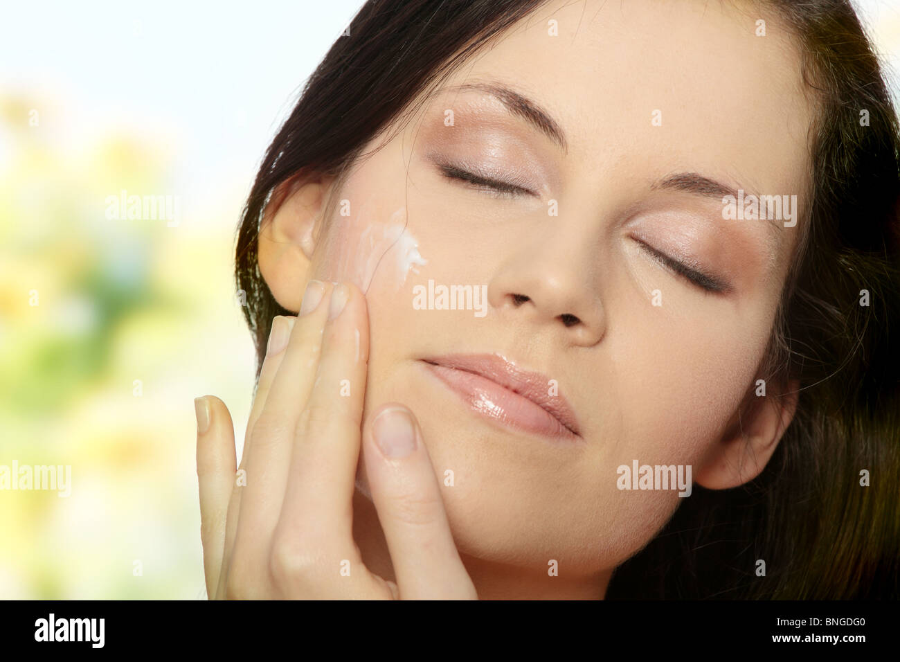 Beautiful young woman with cream Stock Photo - Alamy